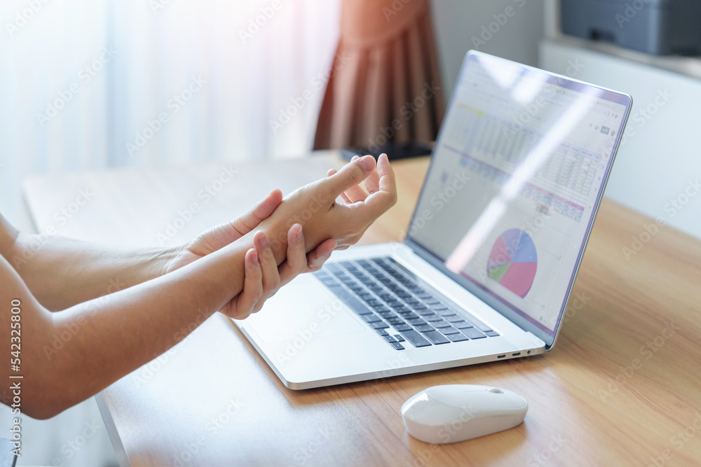 Woman having wrist pain when using mouse during working long time on ...