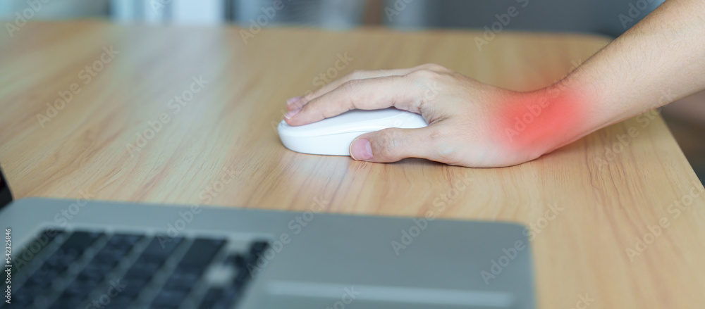 Woman having wrist pain when using mouse during working long time on ...