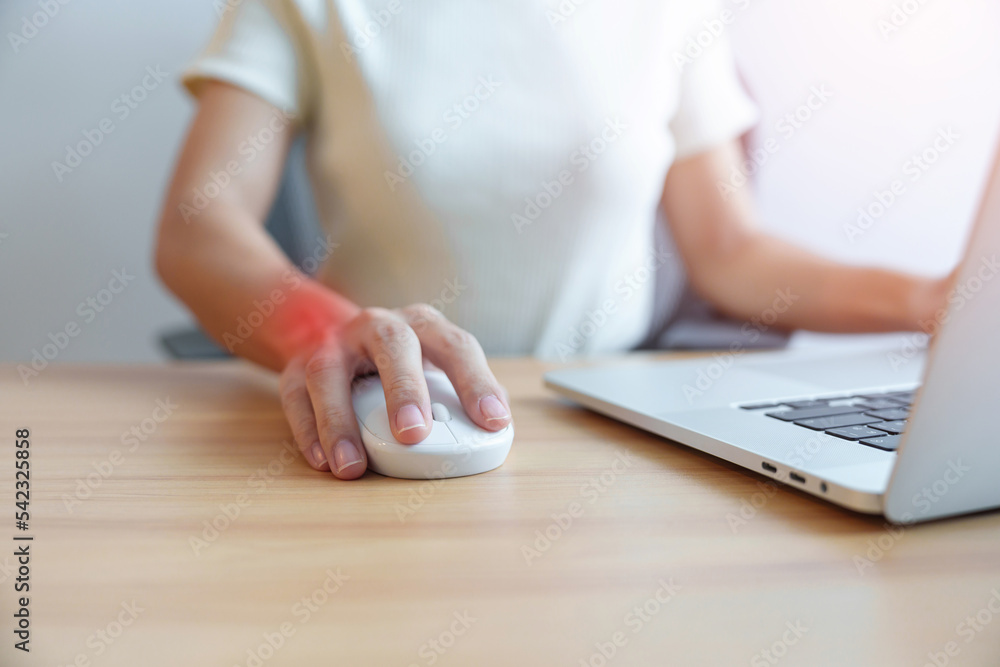 Woman having wrist pain when using mouse during working long time on ...
