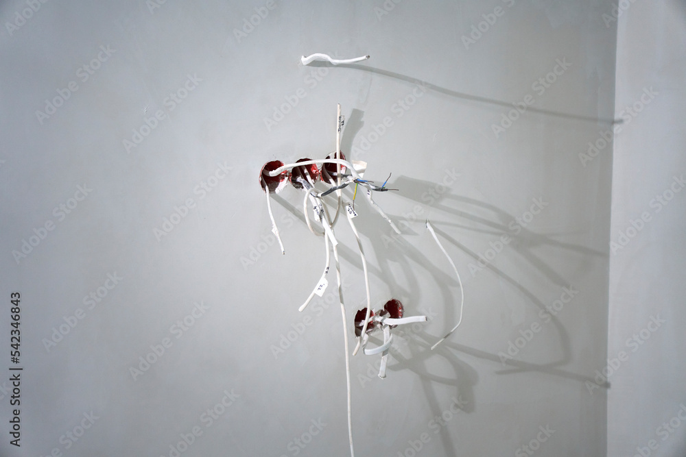 Close-up view of electrical wires sticking out of the wall. House ...