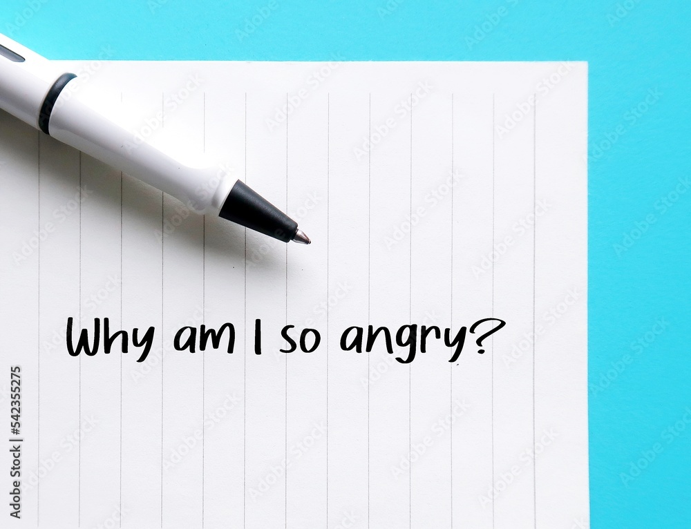 Torn paper on blue background with handwritten text WHY AM I SO ANGRY ...