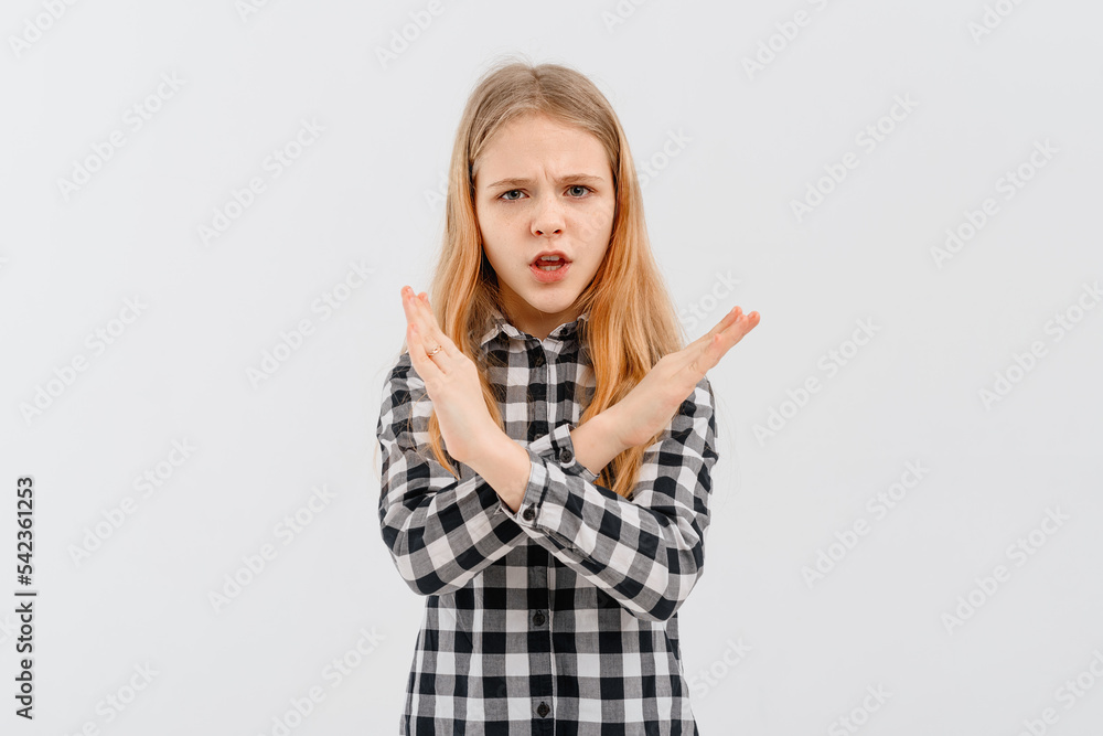 Dont like it. Upset teen girl shows stop, cross hands gesture ...