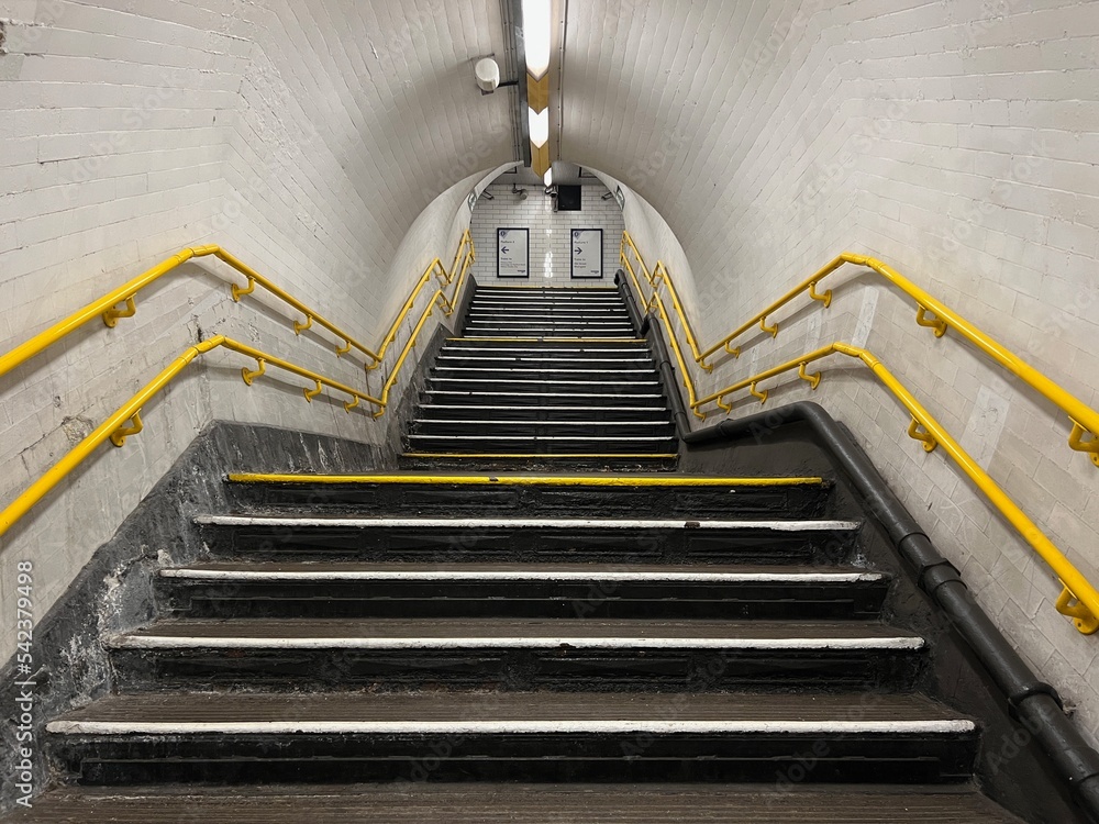 Stair way leading down to rail station platform of London tube tunnel ...