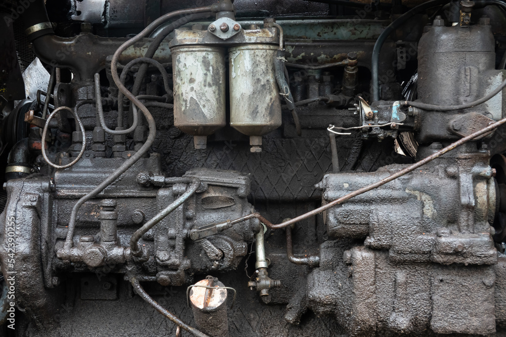 Close-up of an old diesel engine. The surface of the parts is covered ...