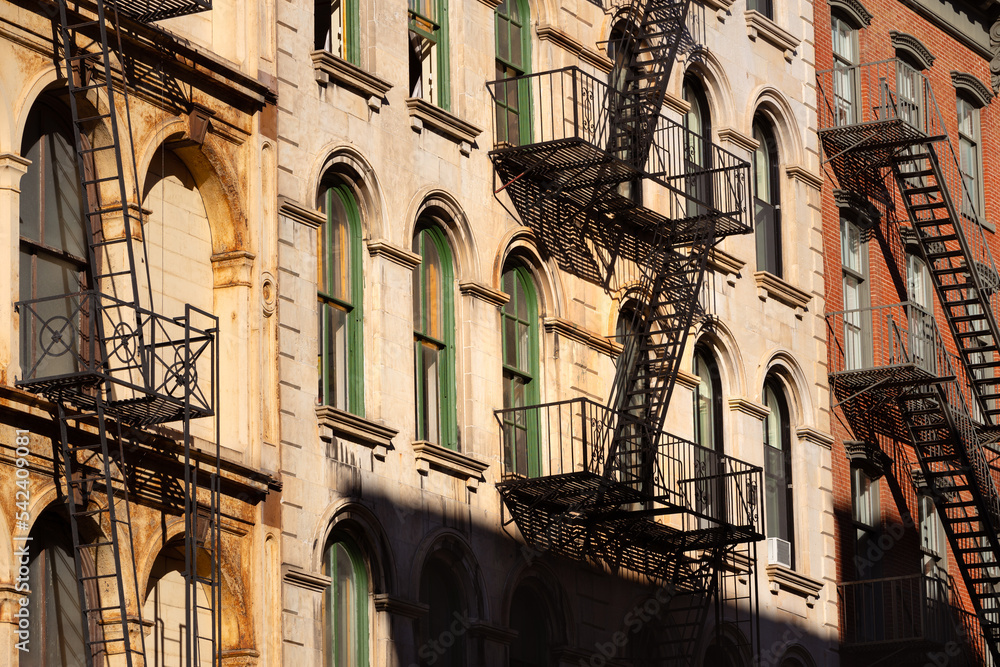 Soho loft buildings with stone and brick facades and fire escapes ...