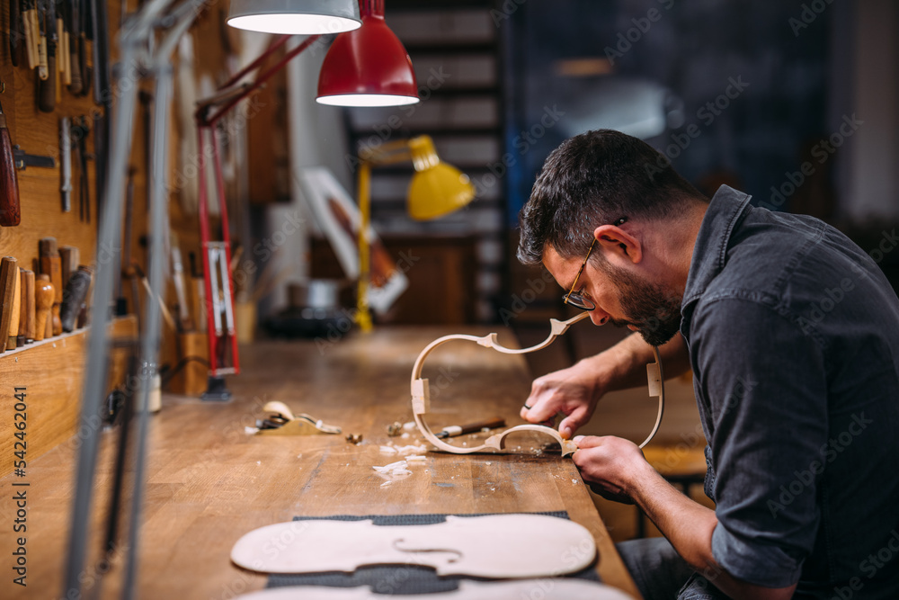 Luthier creating violin ribs in workshop Stock Photo | Adobe Stock