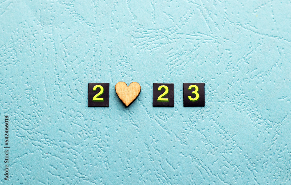 happy 2023 year.small digits numbers in square magnetic shapes on blue ...