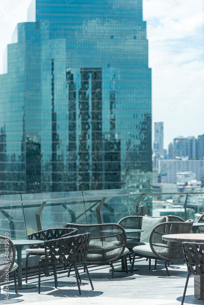 Roof top sky bar table seat with blur skyscraper view background Stock ...
