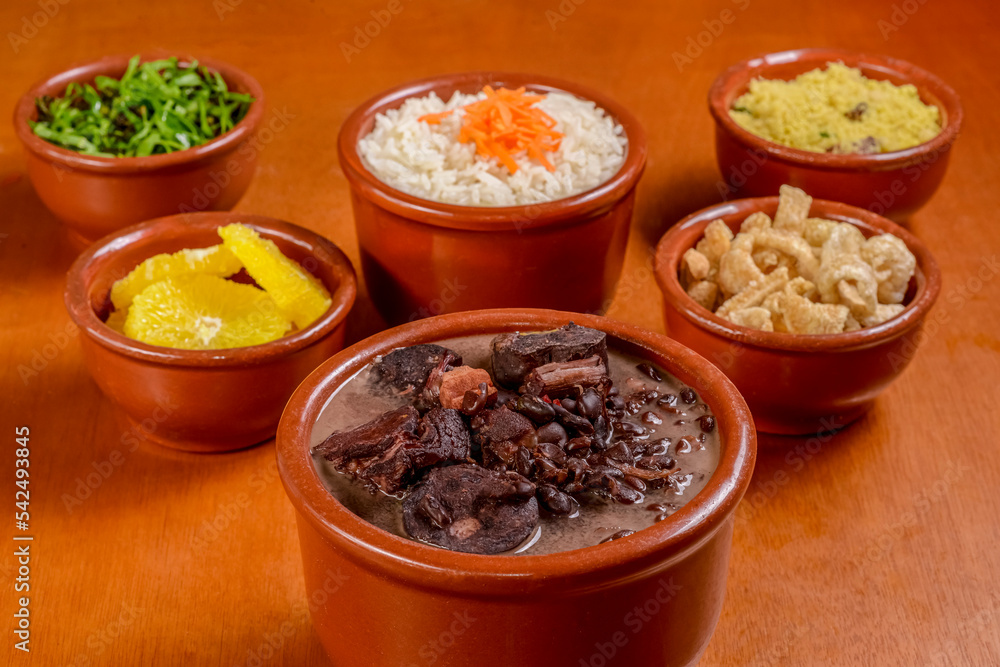 Brazilian feijoada. Food made with black beans, pork and sausage, with ...