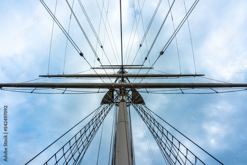 Vertical perspective view of a tall mast spar with ropes and boms on a ...