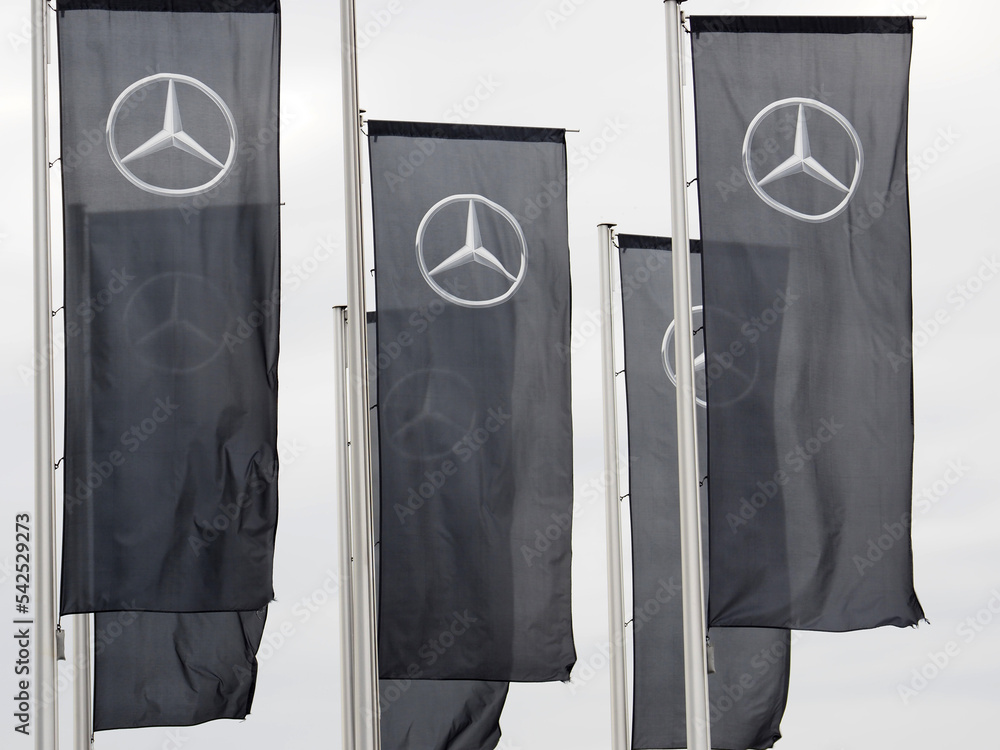 Flags with the Mercedes-Benz logo are seen in front of the Mercedes ...