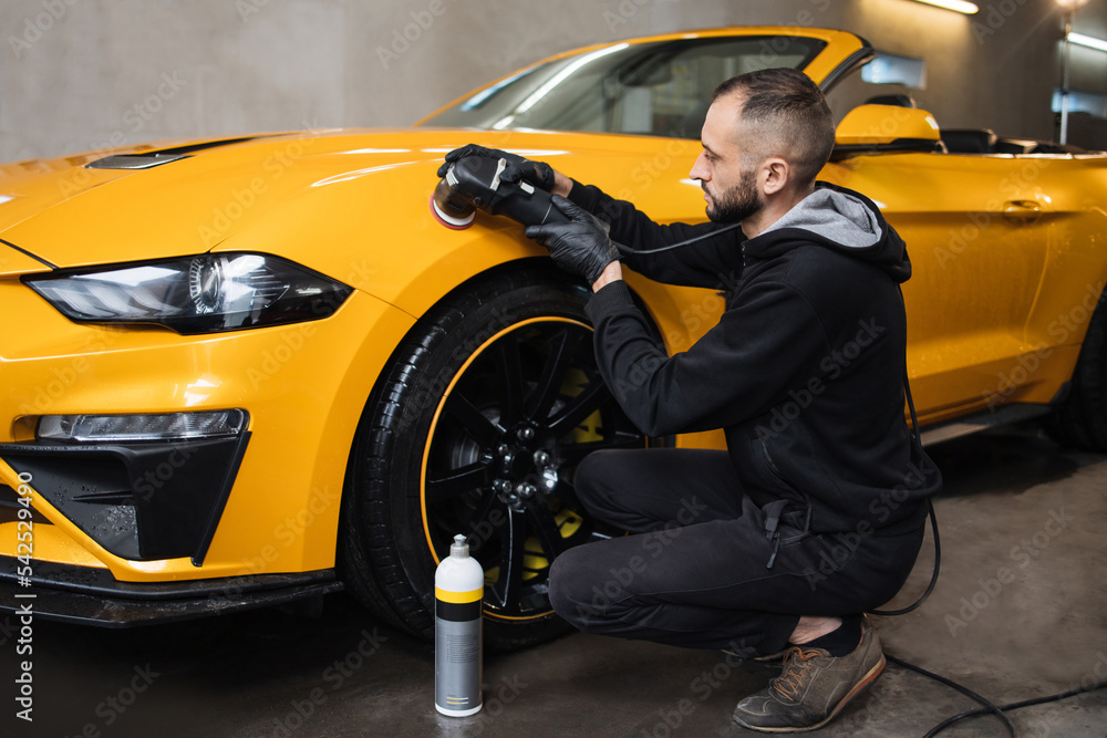 Car detailing and polishing concept. Professional Caucasian male car ...