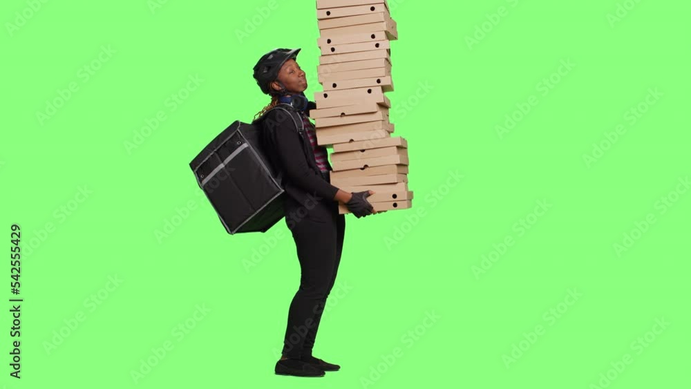 Pizzeria restaurant worker delivering boxes of pizza in pile, carrying ...