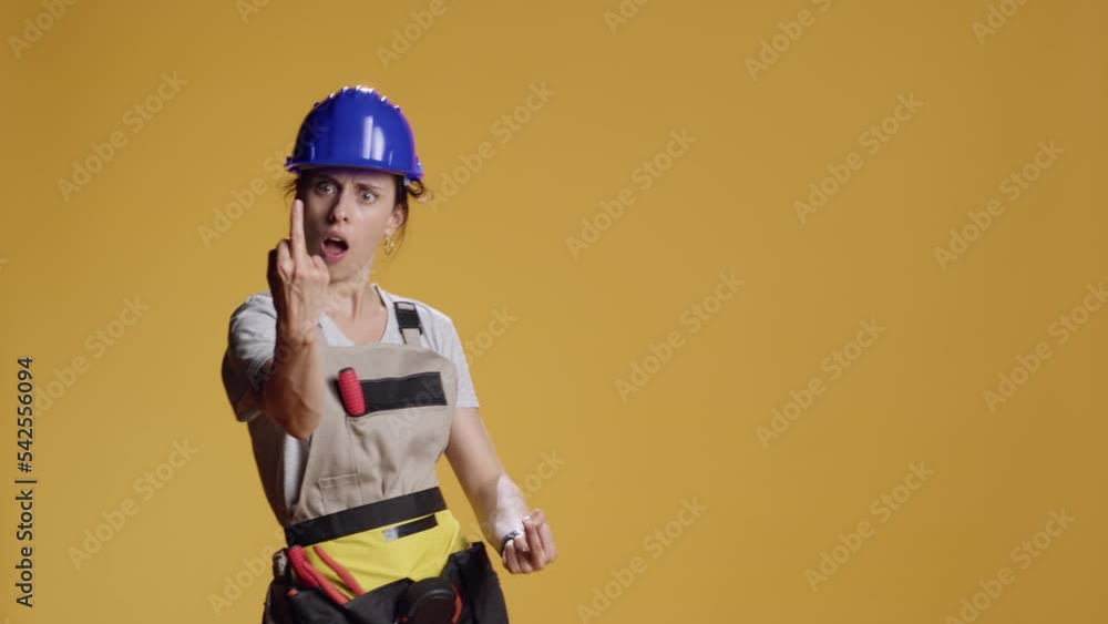Portrait of rude handywoman giving middle finger on camera, acting ...