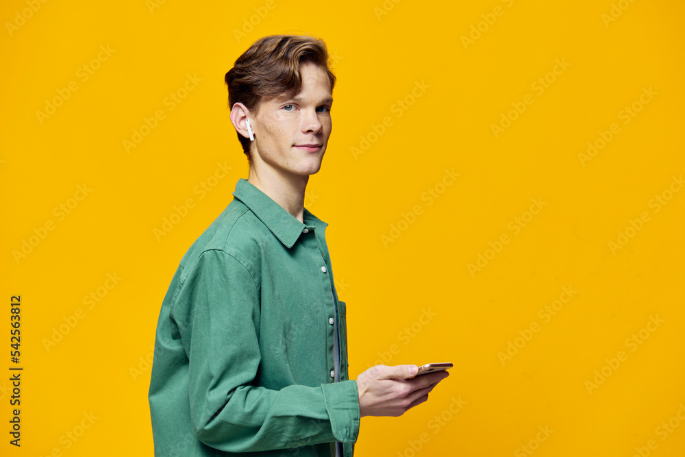 portrait of a man talking through wireless headphones on the phone and ...