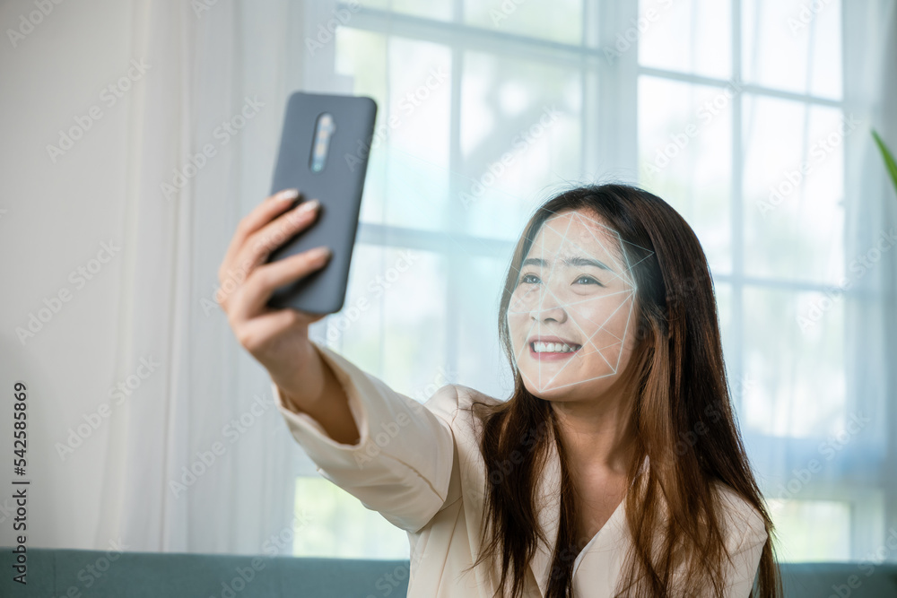 Asian women use smartphone for access control face recognition in ...