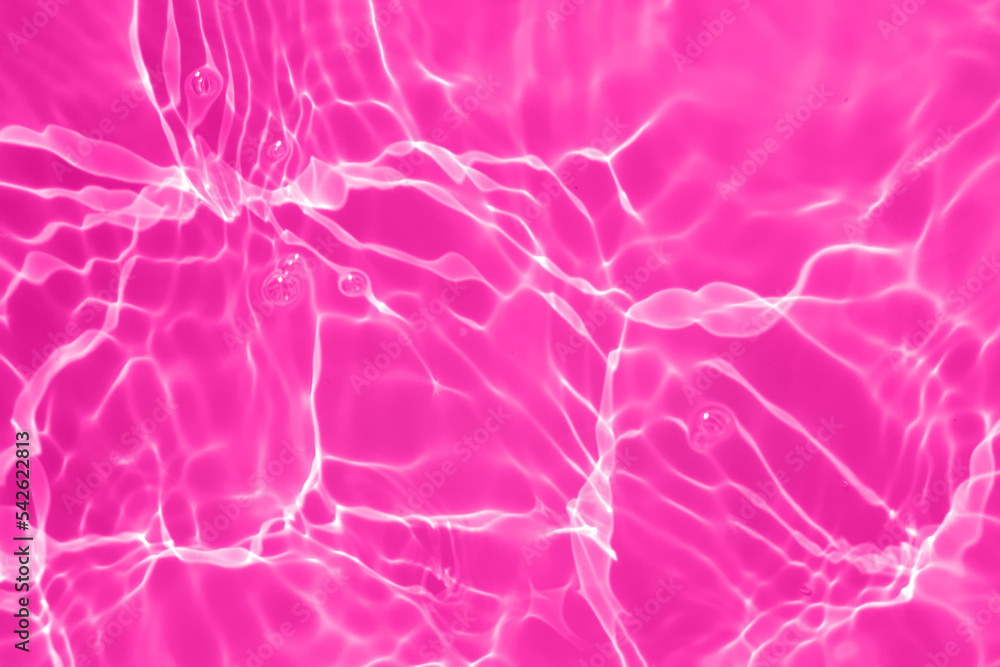 Defocus blurred transparent purple colored clear calm water surface ...