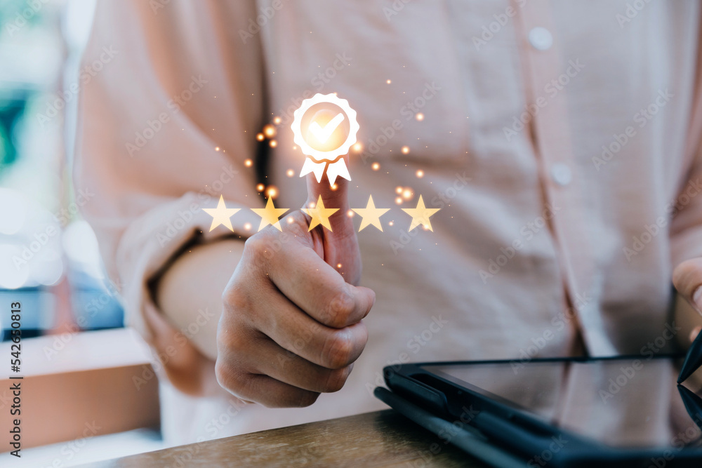 Hand shows the sign of the top service Quality assurance, thumb up and ...