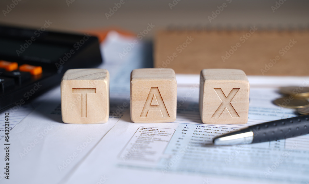 Tax word and number 2021 displayed on a wooden block. Business and tax ...