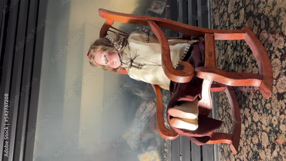 Video Stock An old and very strange doll sits in a rocking chair ...