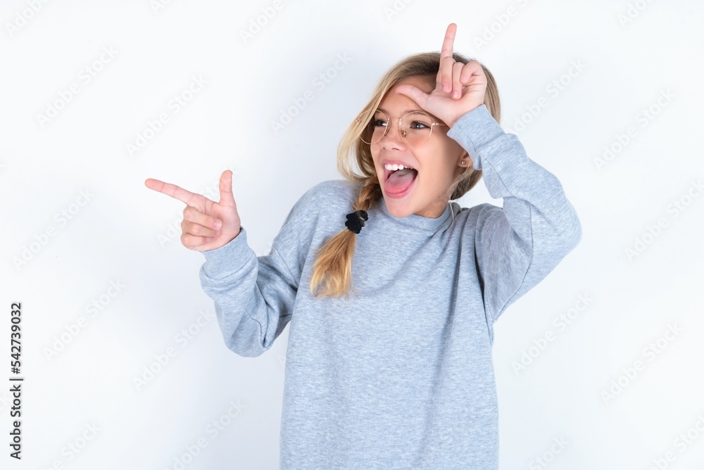 beautiful caucasian teen girl wearing gray sweater over white wall ...