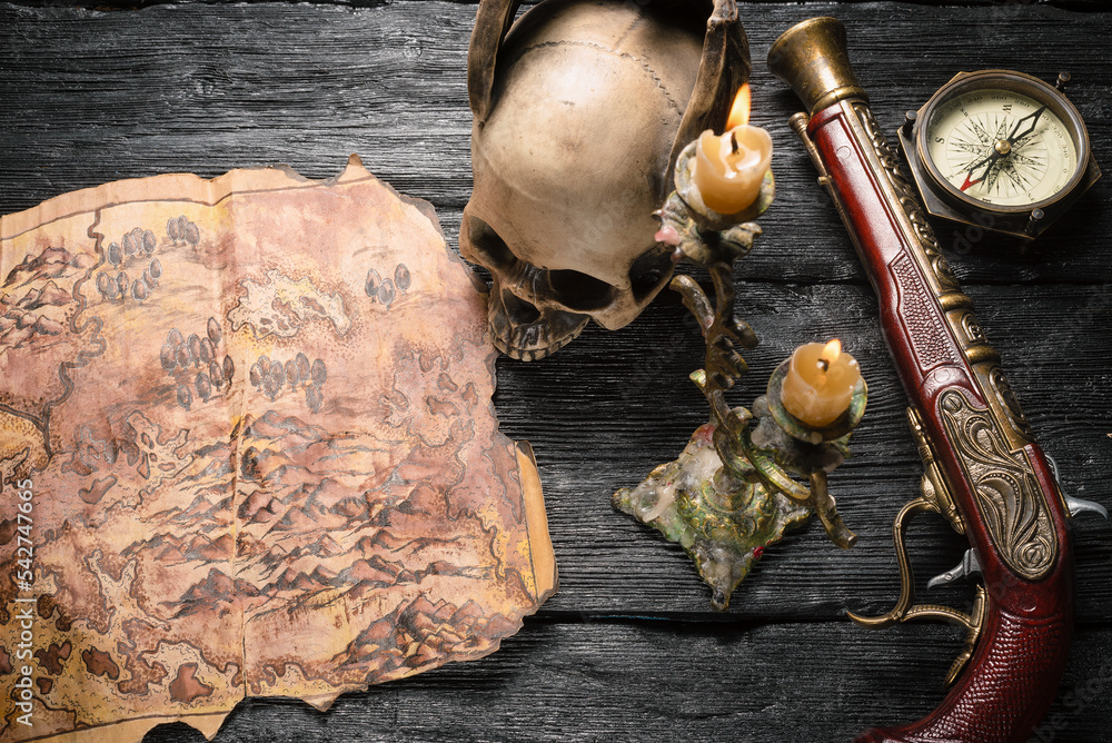 Ancient pirate treasure map and musket gun on the pirate table top view ...