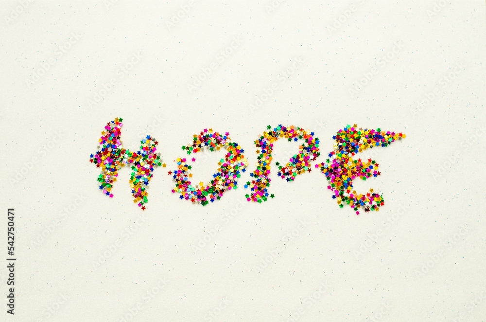 Hope word written with colourful star confetti glittering on white ...