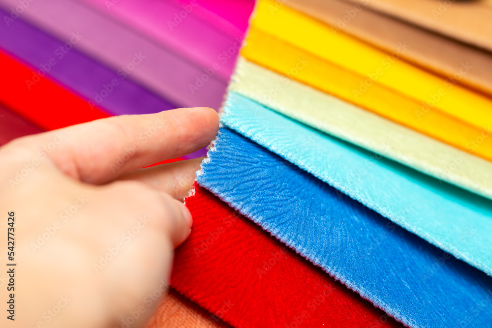 Fabric swatches in different colors are stacked for selection. A ...