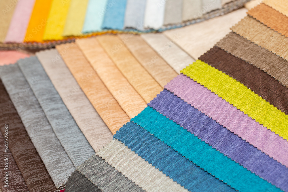 Fabric swatches in different colors are stacked for selection. A ...