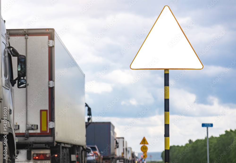 Trucks are stuck in traffic. A column of semi-trailers on the freeway ...