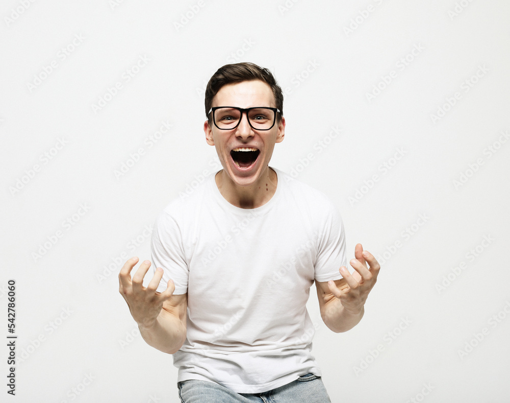 portrait of shocked stunned surprised young man eyes and mouth wide ...