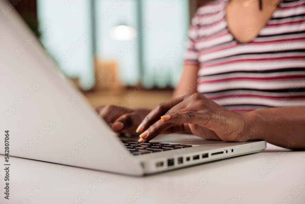 Foto de Woman hands typing on laptop keyboard at workplace desk close ...