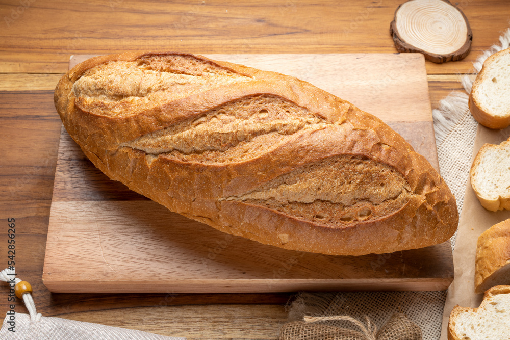 Baked baguette and multigrain loaf bread in Paper bag ready to serve ...