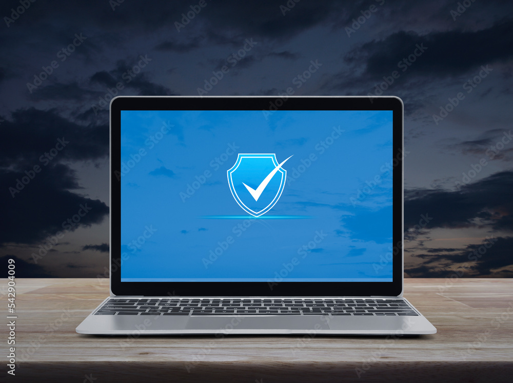 Security shield with check mark icon on modern laptop computer monitor ...