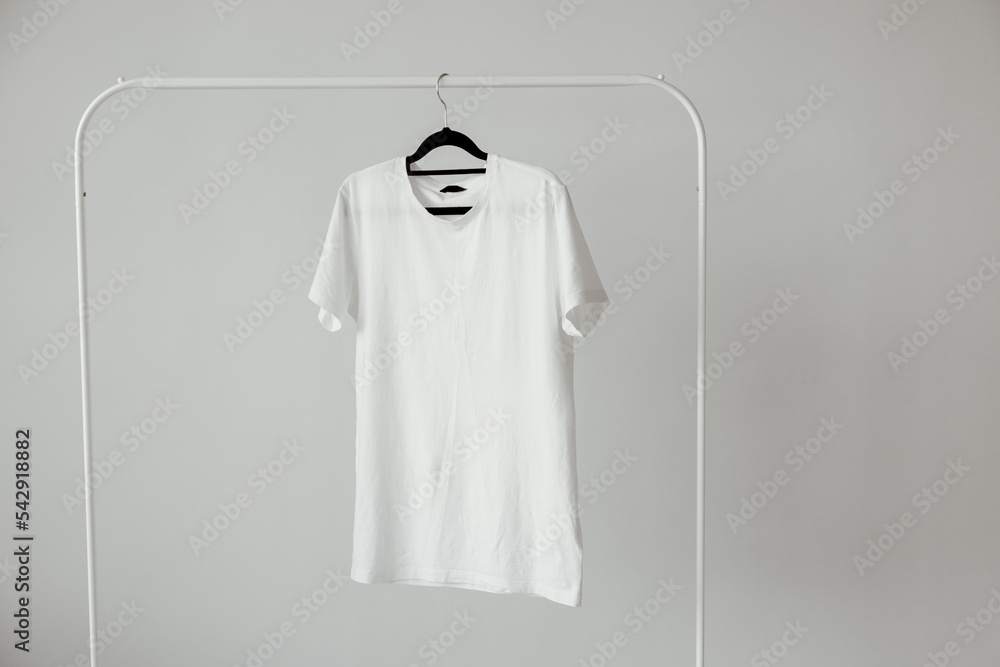 Blank White T-Shirt Mock-up hanging on white Rack Hanger, front view ...