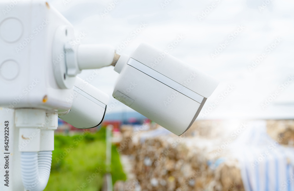 Side view of white CCTV security camera video system for safety at a ...