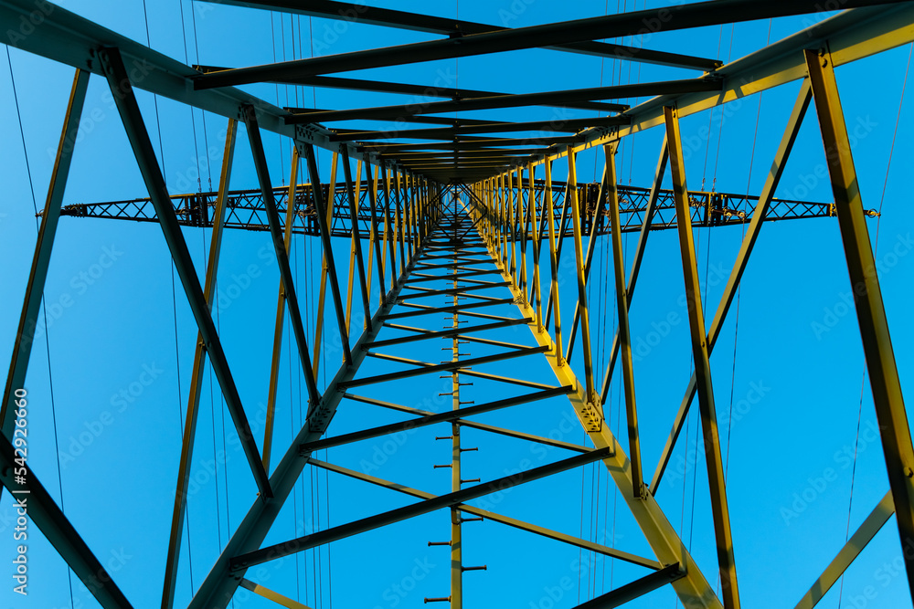 Foto de Green steel structure of a high voltage pylon illuminated by ...