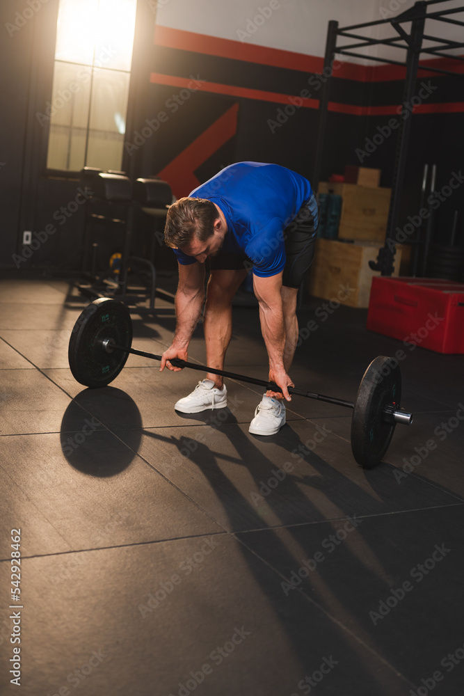 Foto de Young fit and athlete male in training clothing working out in ...