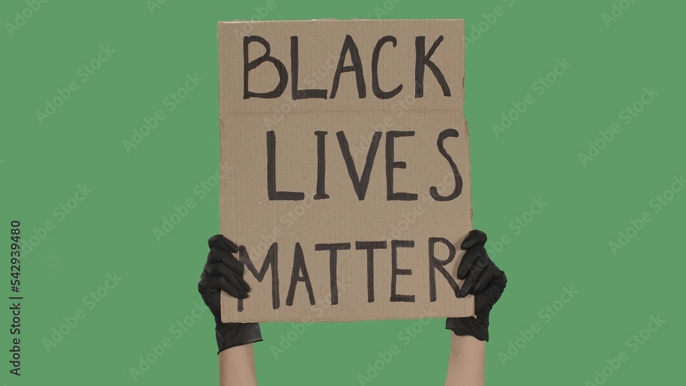 Hands of an unknown person in black gloves raise cardboard poster BLACK ...