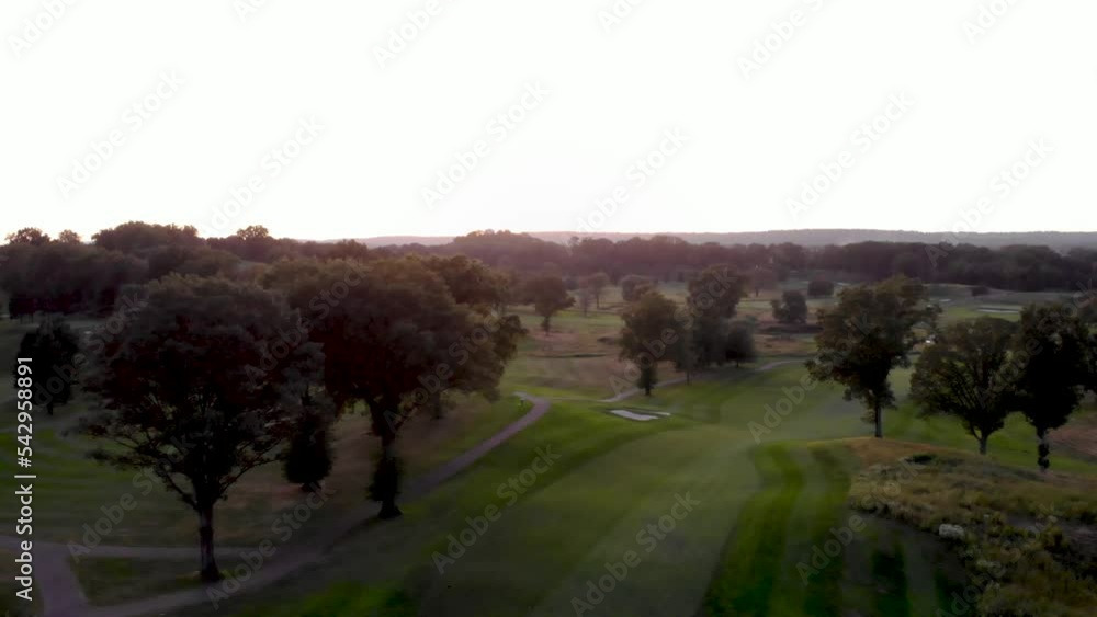 Flying Through Golf Course at Sunset Stock Video | Adobe Stock