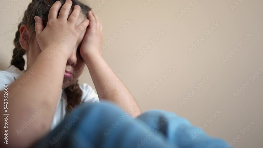 sad girl sitting in the corner crying a covered her face with her hands ...