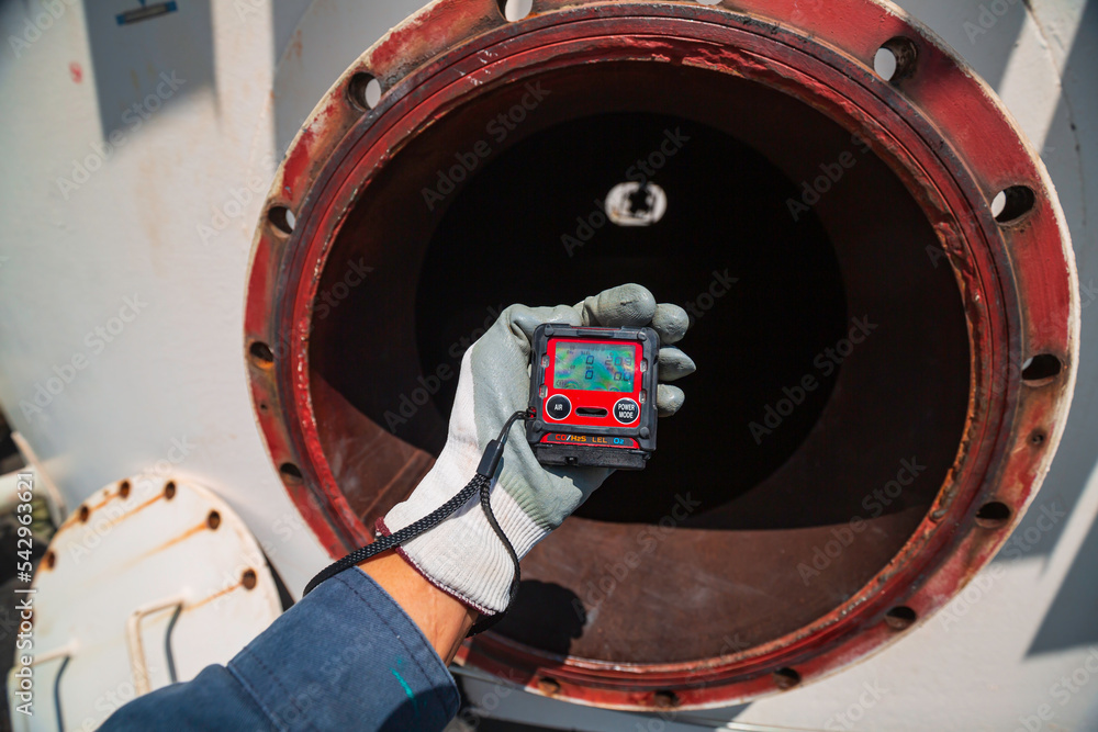 Worker hand holding gas detector inspection safety gas testing at front ...