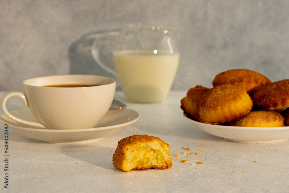 Delicious snack: a cup of black tea with milk and a plate of cookies on ...
