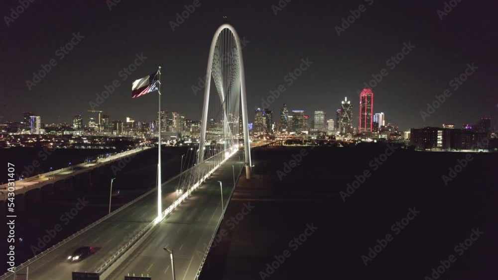 Dallas skyline aerial at night fly across famous Arched bridge with ...