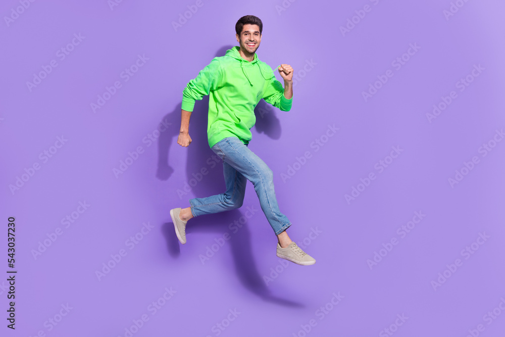 Full length photo of good mood man wear green jumping high running fast ...
