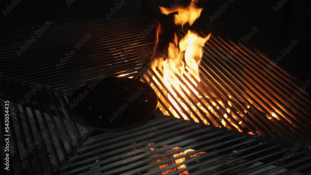 grill. Barbecue grill with fire flames. rotating large grill in a ...