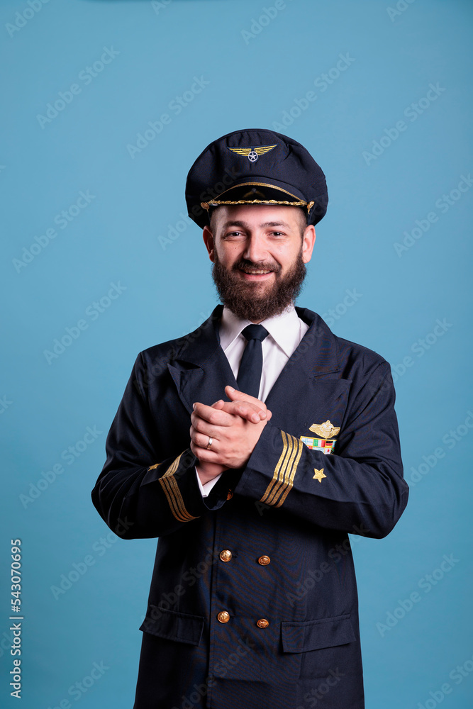 Smiling excited plane pilot in professional uniform clapping hands ...