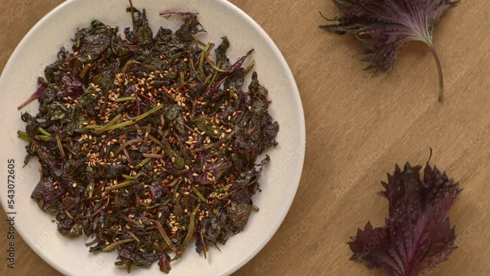 Asian style Shiso (Perilla) leaves stir fry with sesame seeds. Top view ...