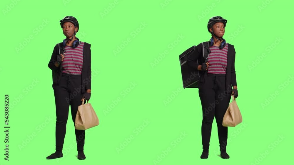 Cheerful woman delivering fastfood order in paperbag, standing on full ...