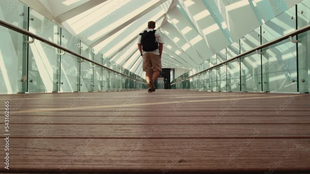 Low angle view of male solo trveler with black bacpack walks in ...